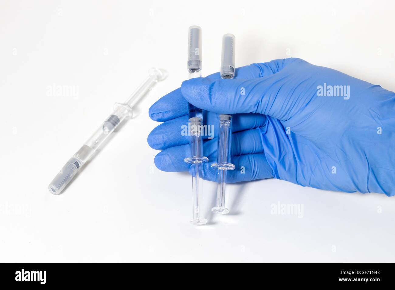 Hand holding syringe isolated on white Stock Photo - Alamy