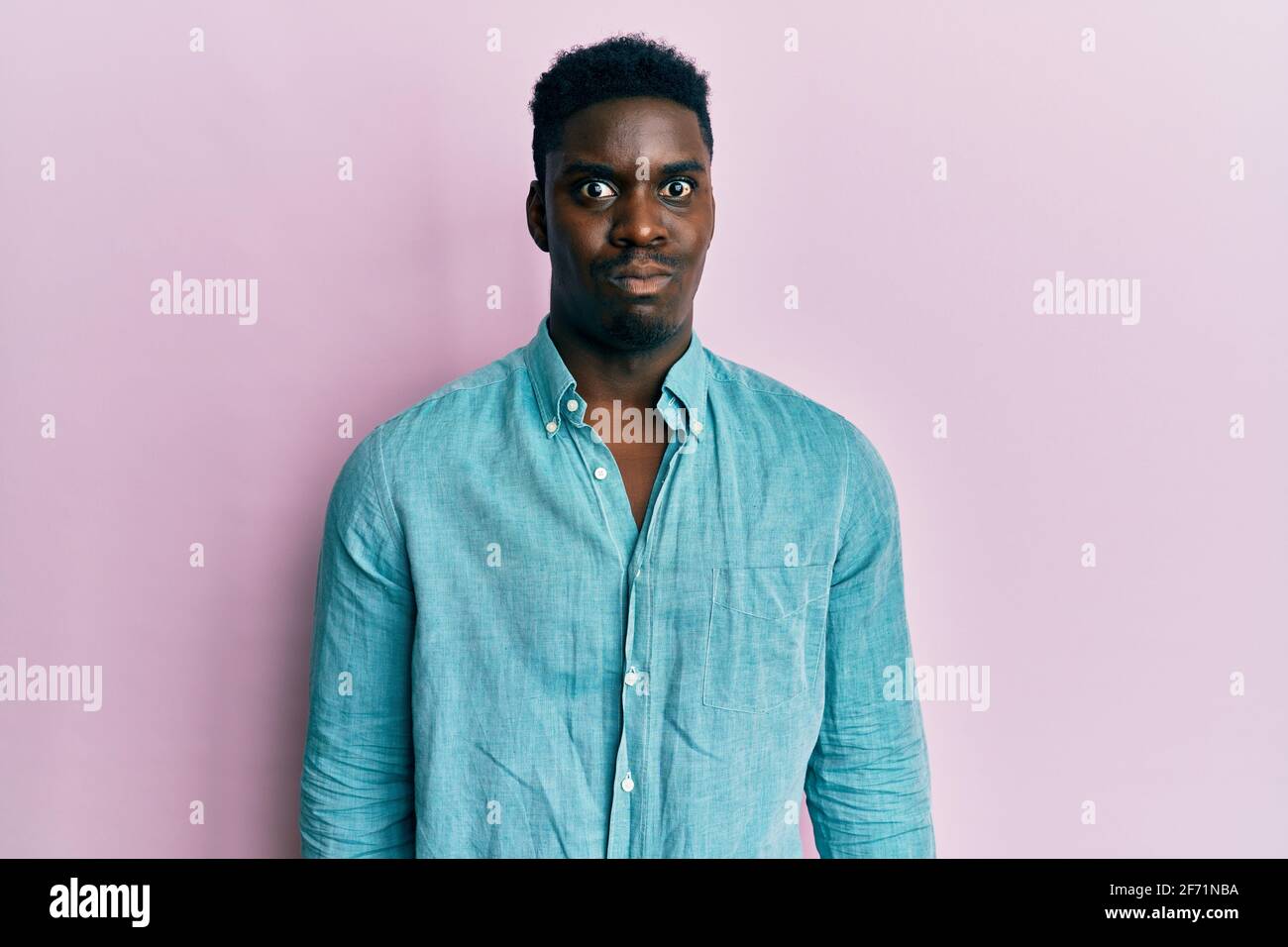 Handsome black man wearing casual clothes puffing cheeks with funny ...