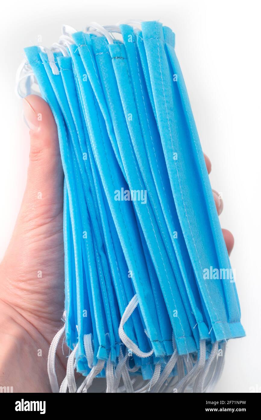 Hand holding medical mask on white background Stock Photo - Alamy