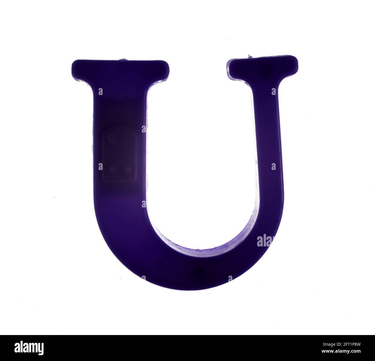 Plastic letter U on magnet isolated on white background, top view Stock ...