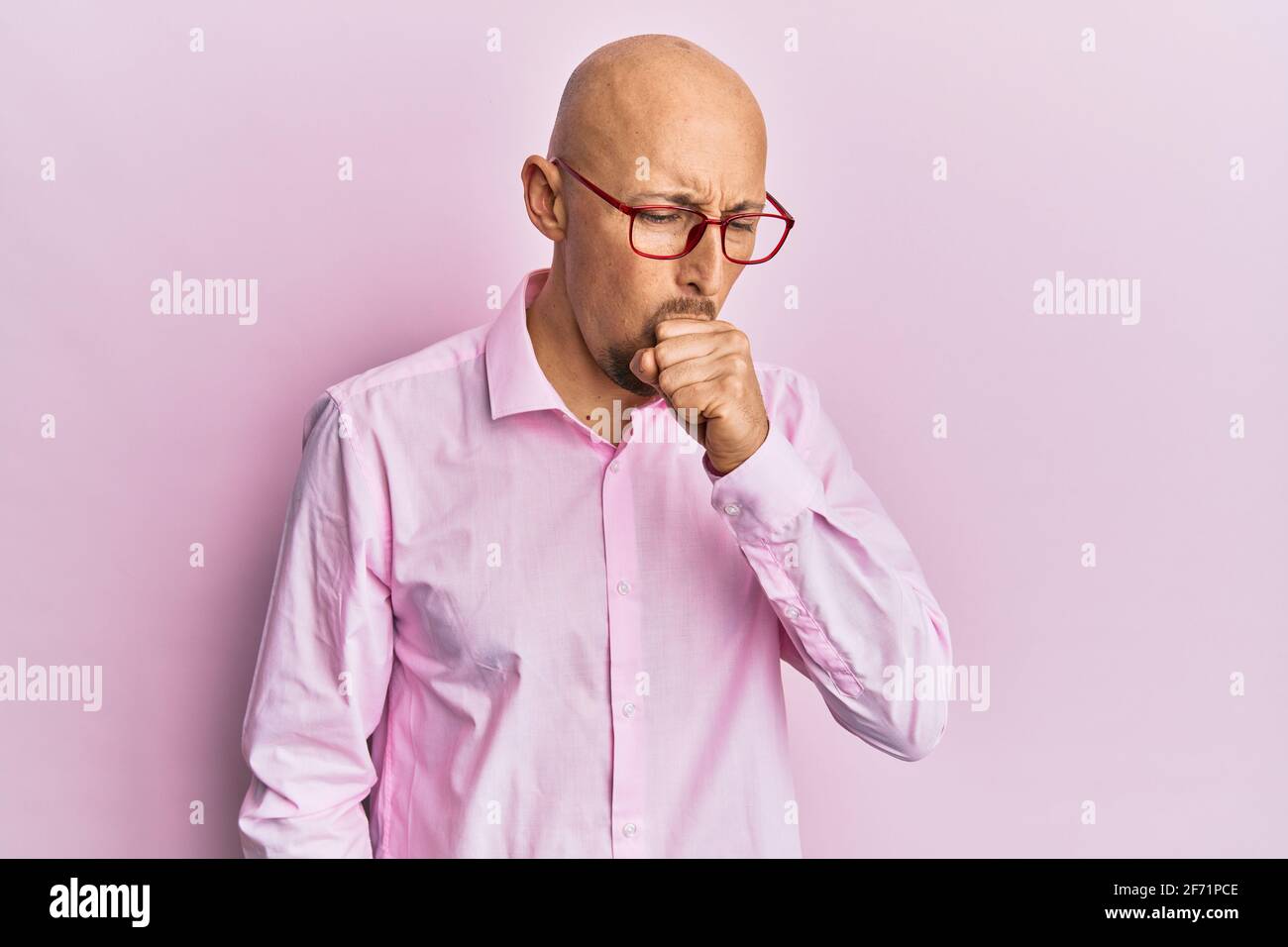 Bald man with beard wearing casual clothes and glasses feeling unwell ...
