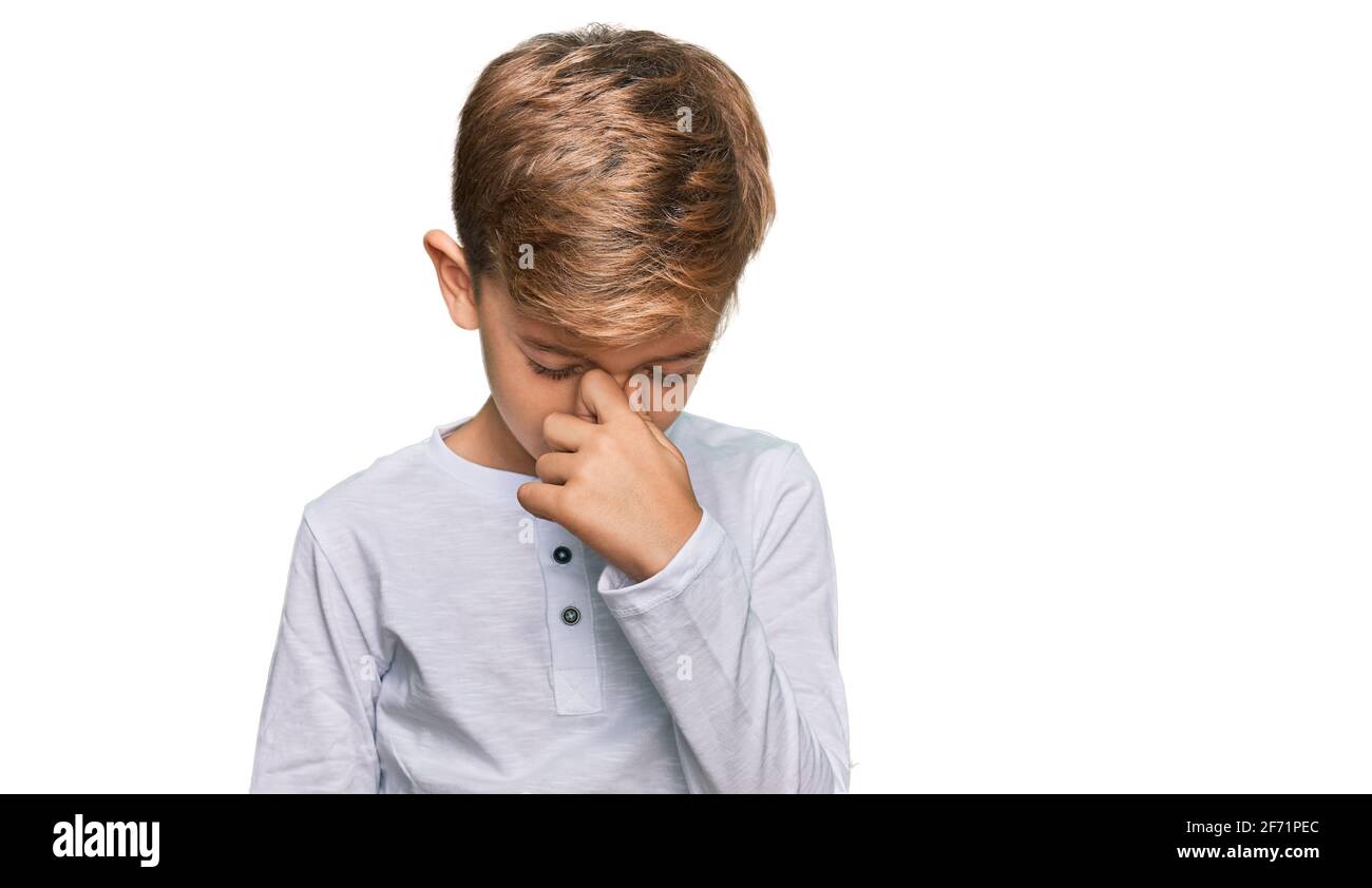 Little caucasian boy kid wearing casual clothes tired rubbing nose and ...