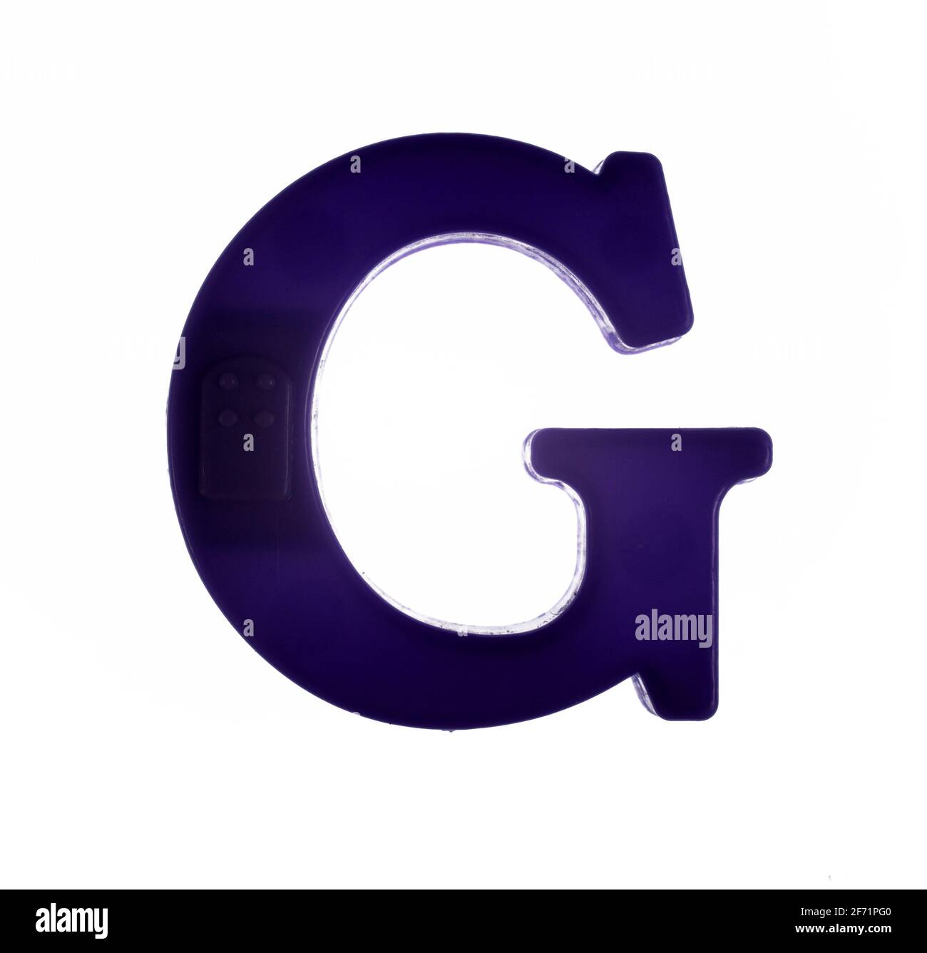 Plastic letter G on magnet isolated on white background, top view Stock ...