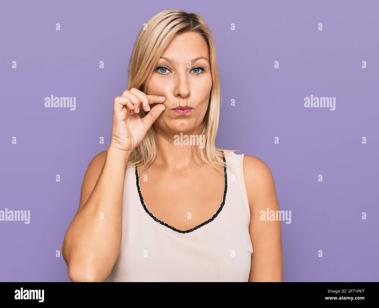 Middle age caucasian woman wearing casual clothes mouth and lips shut ...