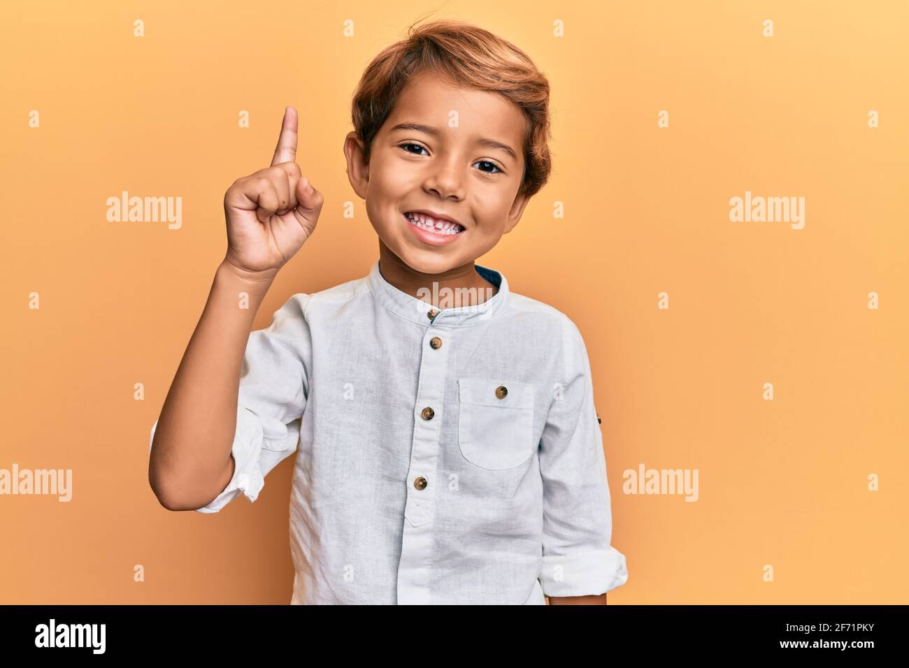 Adorable latin kid wearing casual clothes smiling with an idea or ...