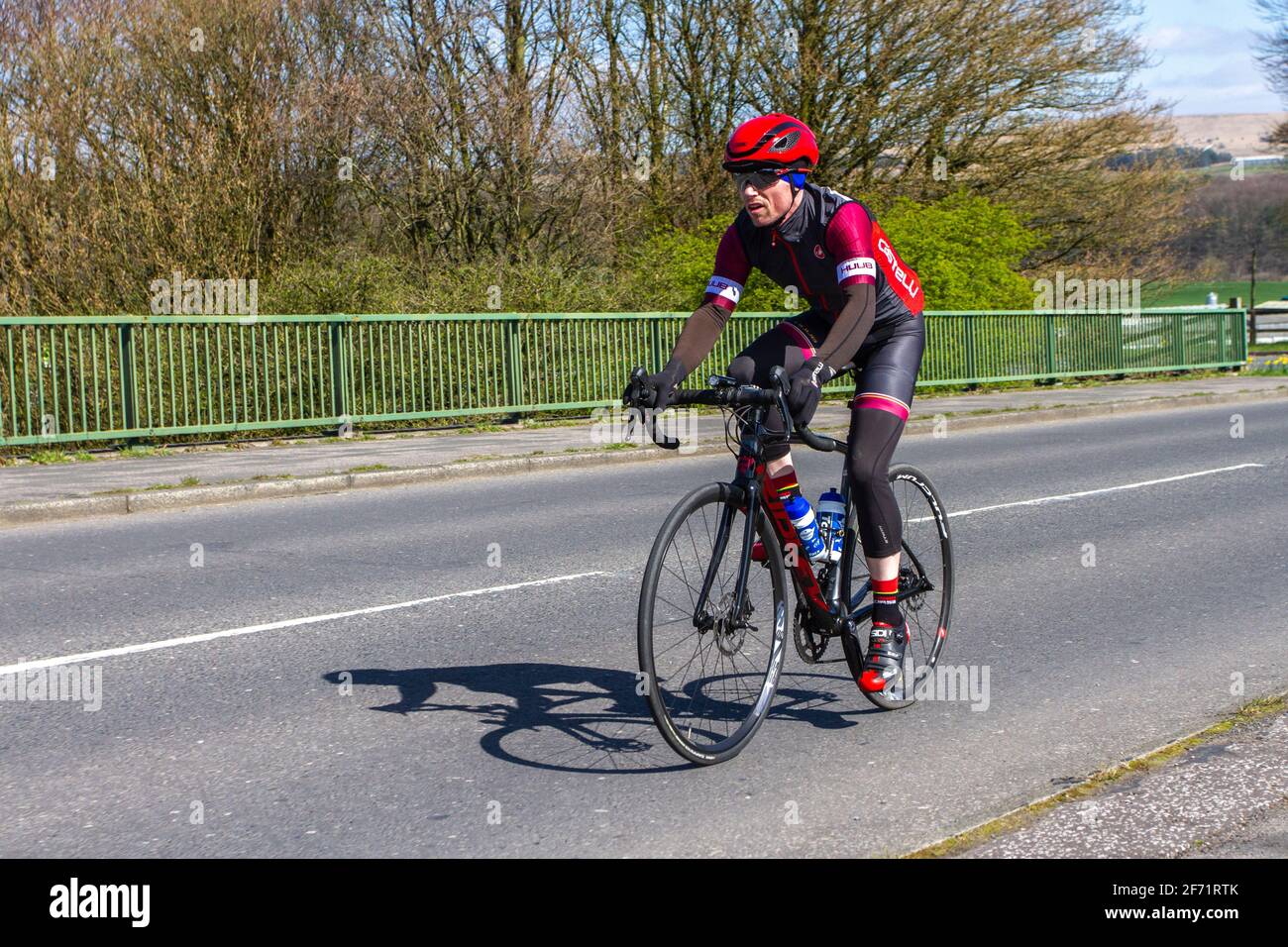 Male cyclist riding sports Ridley road bike on countryside route ...