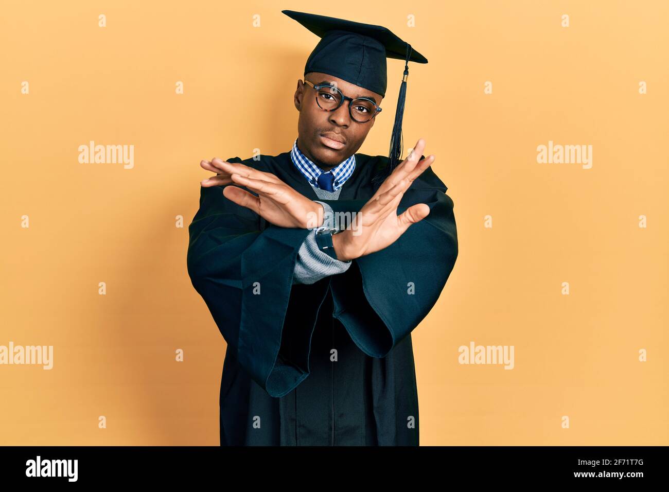 Young african american man wearing graduation cap and ceremony robe ...