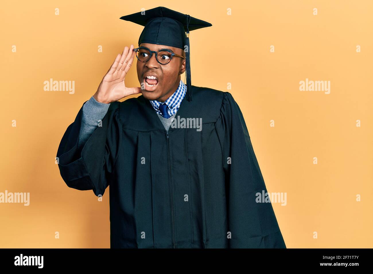 Young african american man wearing graduation cap and ceremony robe ...