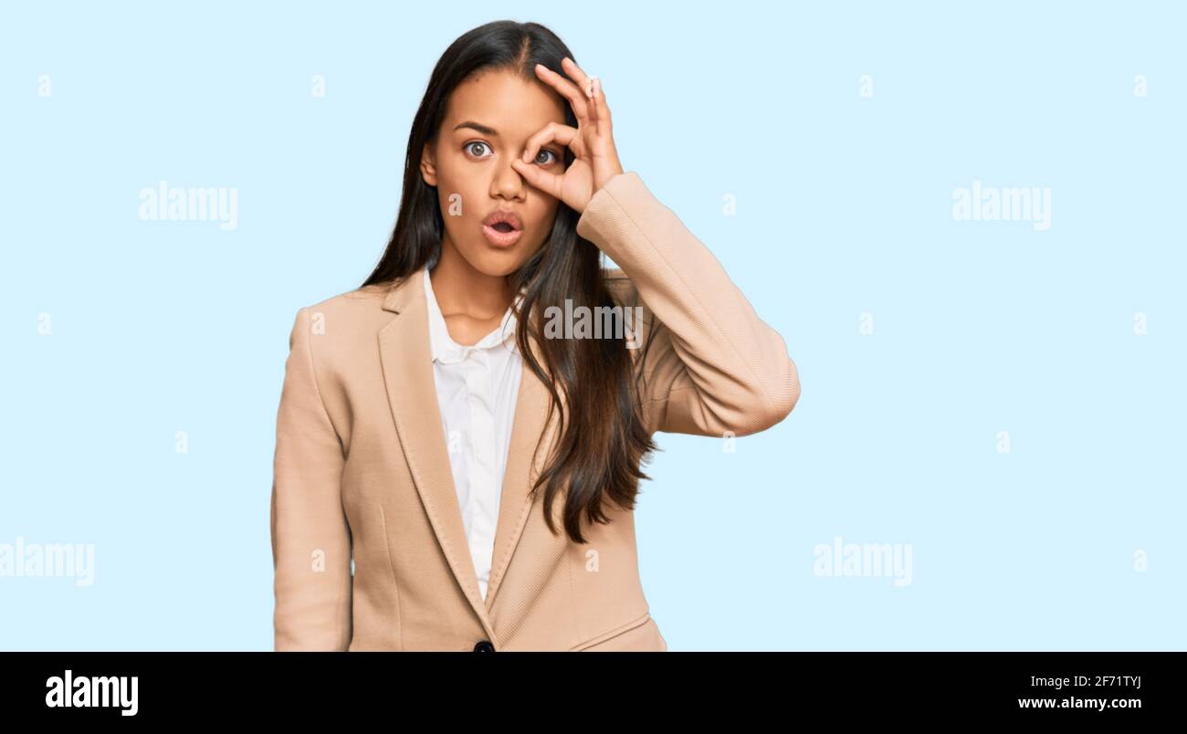 Beautiful hispanic woman wearing business jacket doing ok gesture ...
