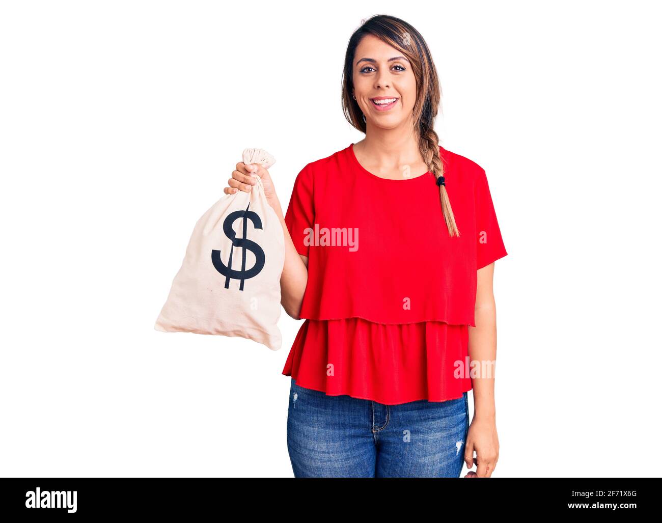 Young beautiful woman holding money bag with dollar symbol looking ...
