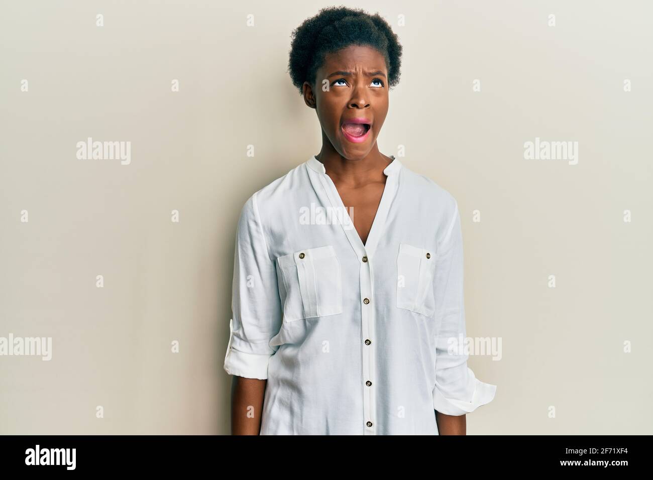 Young african american girl wearing casual clothes angry and mad ...