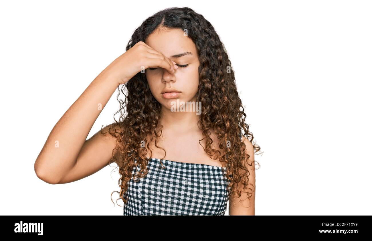 Teenager hispanic girl wearing casual clothes tired rubbing nose and ...