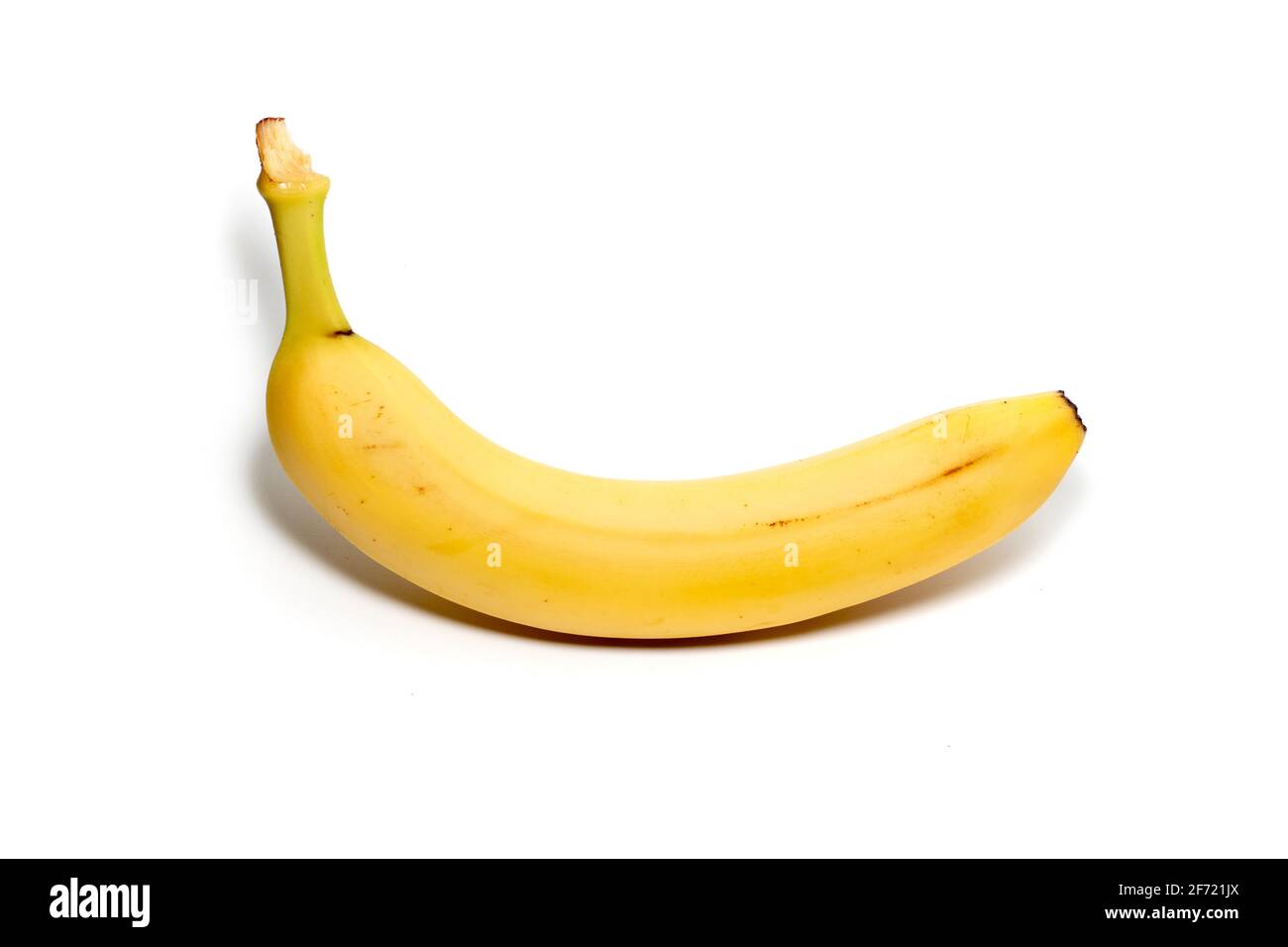 Single banana against white background Stock Photo - Alamy