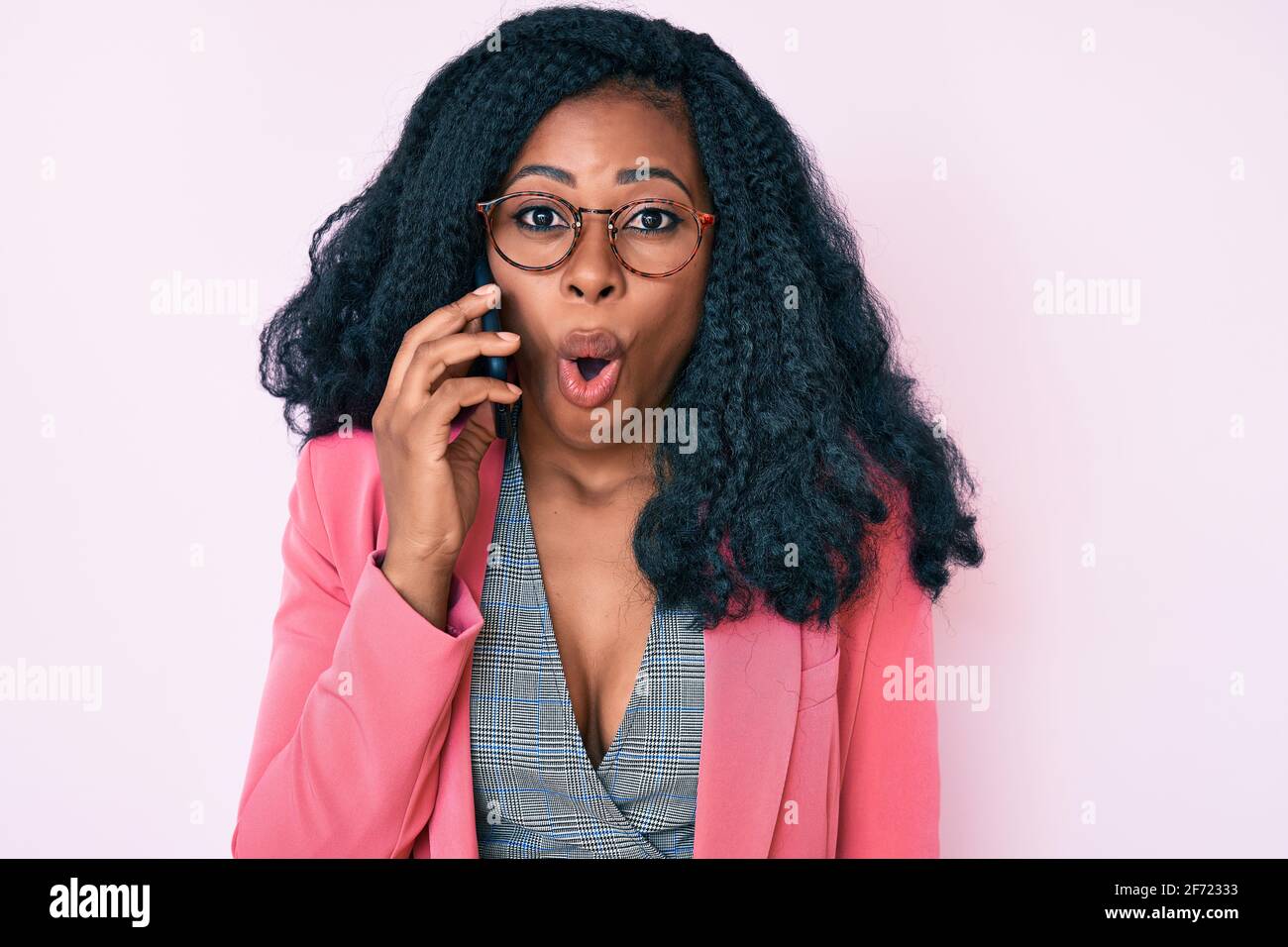 Beautiful african woman having conversation talking on the smartphone ...