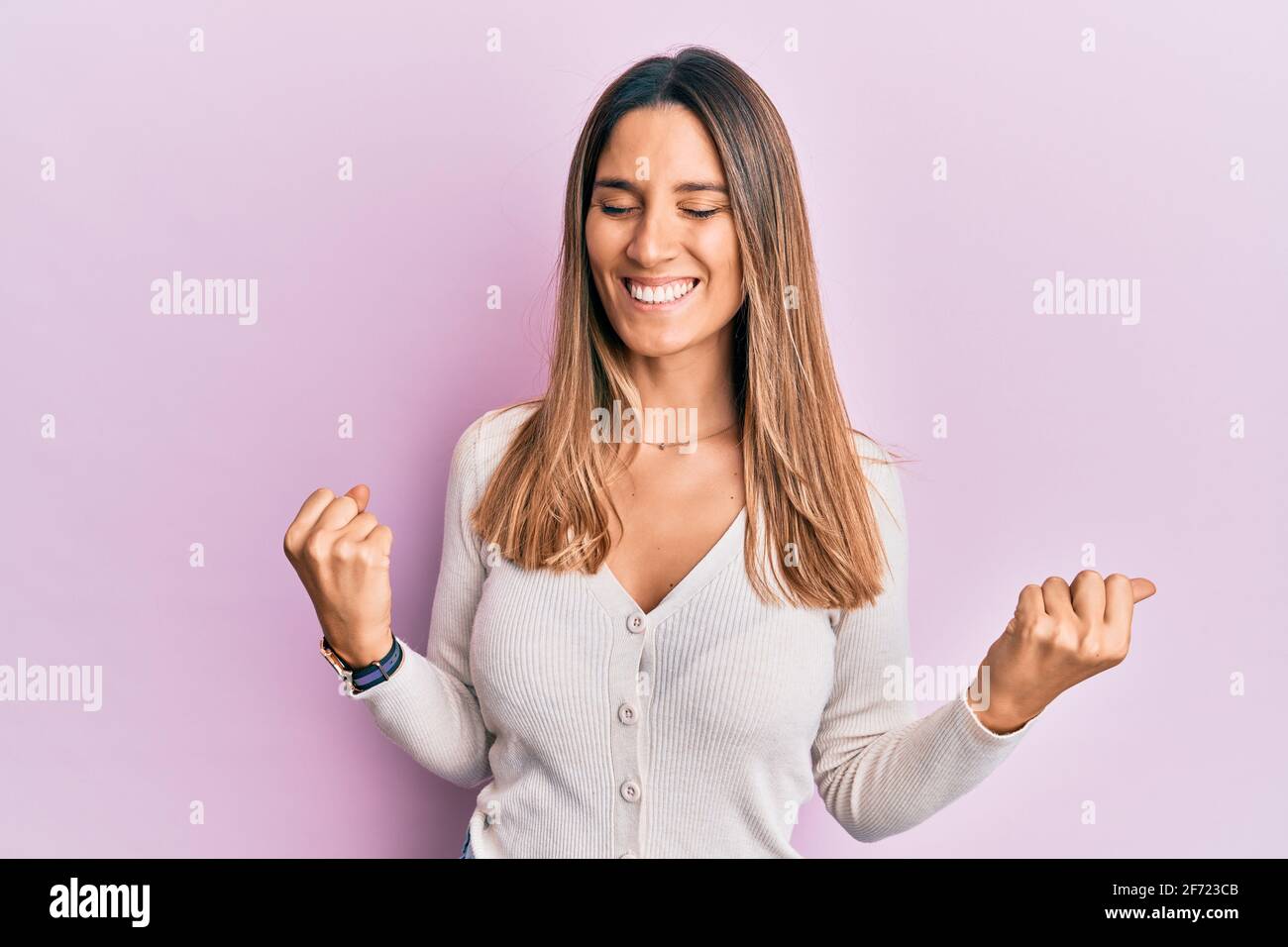 Brunette young woman wearing casual clothes celebrating surprised and ...