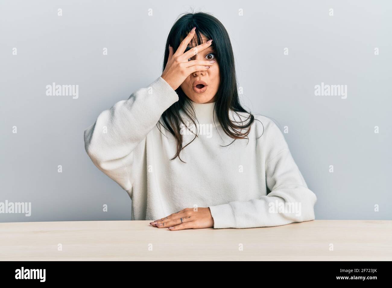 Young brunette woman with bangs wearing casual clothes sitting on the ... Young brunette woman with bangs wearing casual clothes sitting on the ...