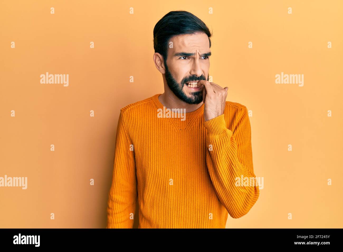 Young hispanic man wearing casual clothes looking stressed and nervous ...