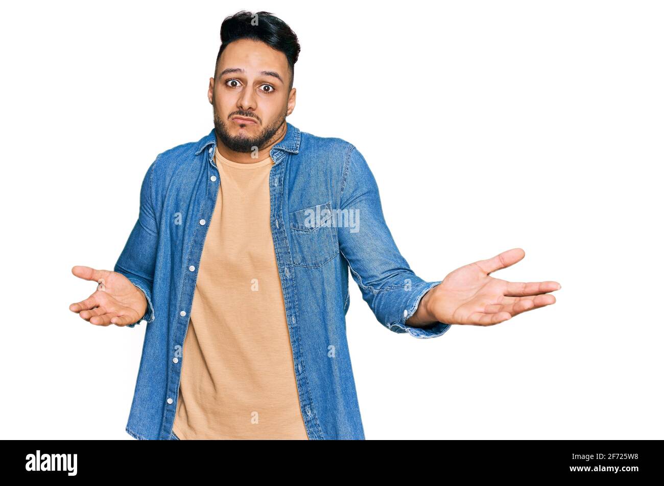 Young arab man wearing casual clothes clueless and confused expression ...