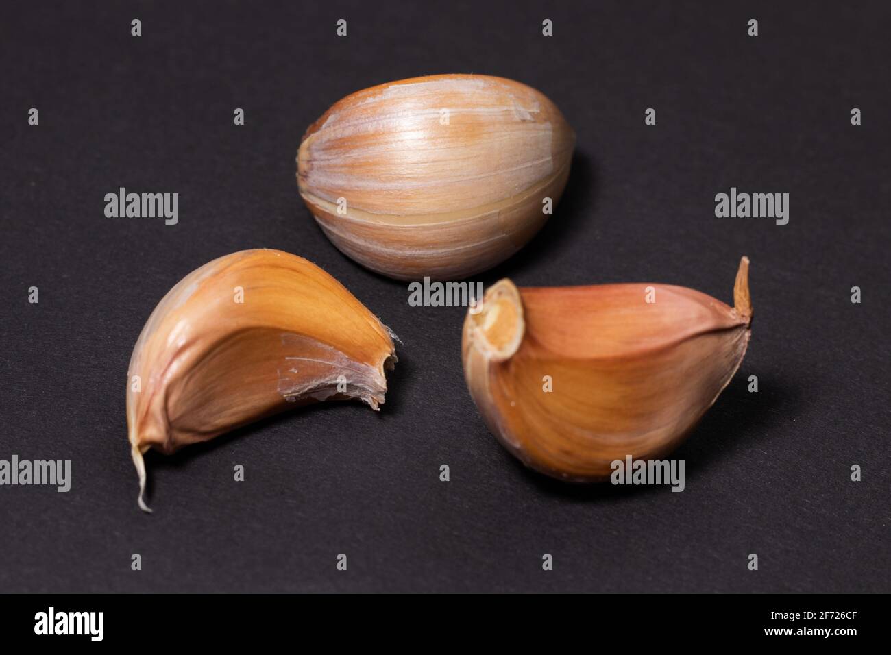 Garlic clove cloves healthy spice on a darck background Stock Photo - Alamy
