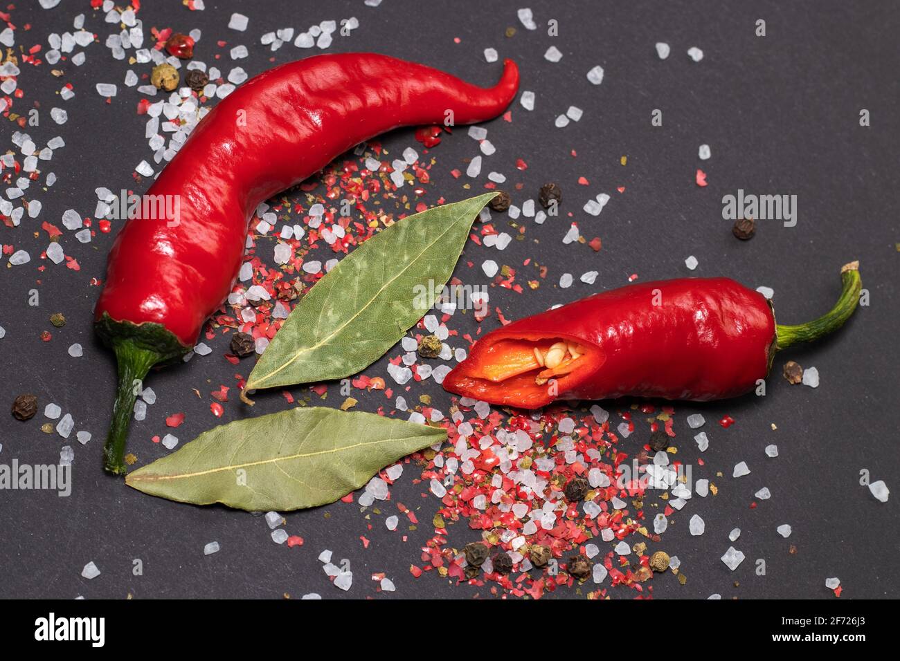 Sea salt and red hot pepper with bay leaf and colorful peppercorns on ...