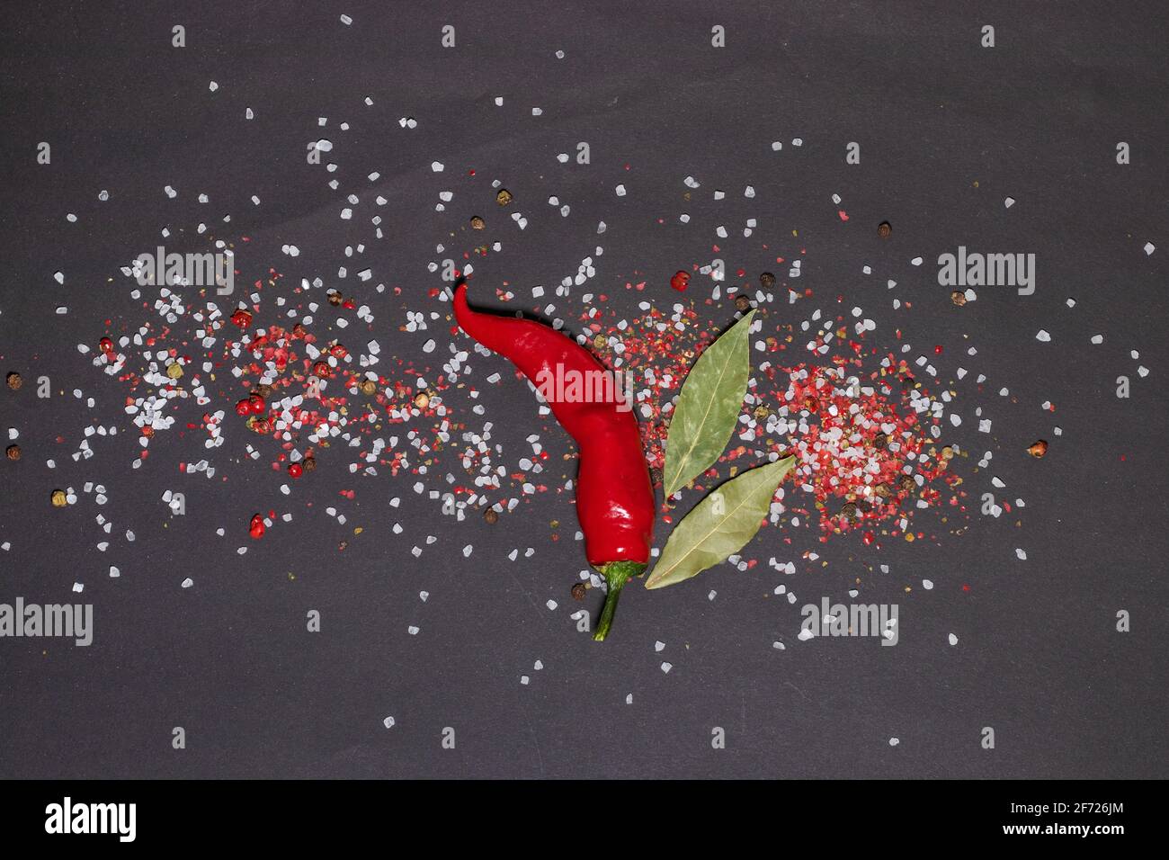 Sea salt and red hot pepper with bay leaf and colorful peppercorns on ...