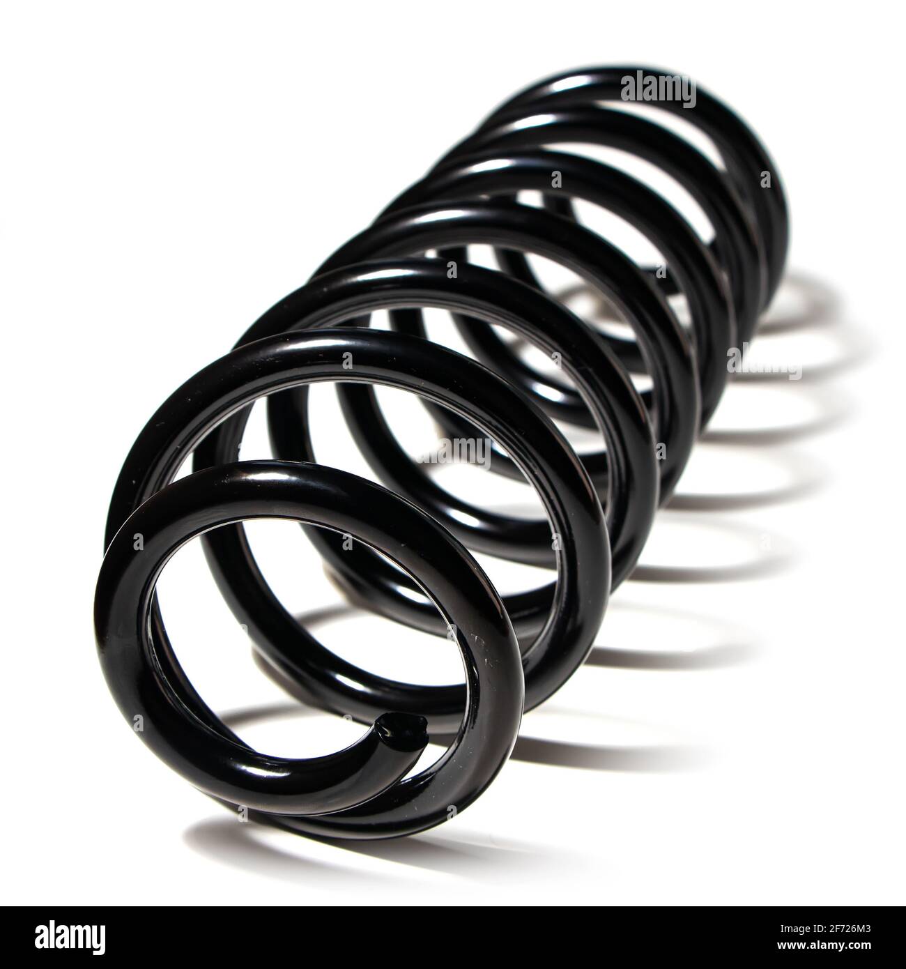 Dark metal spring isolated on white background Stock Photo - Alamy