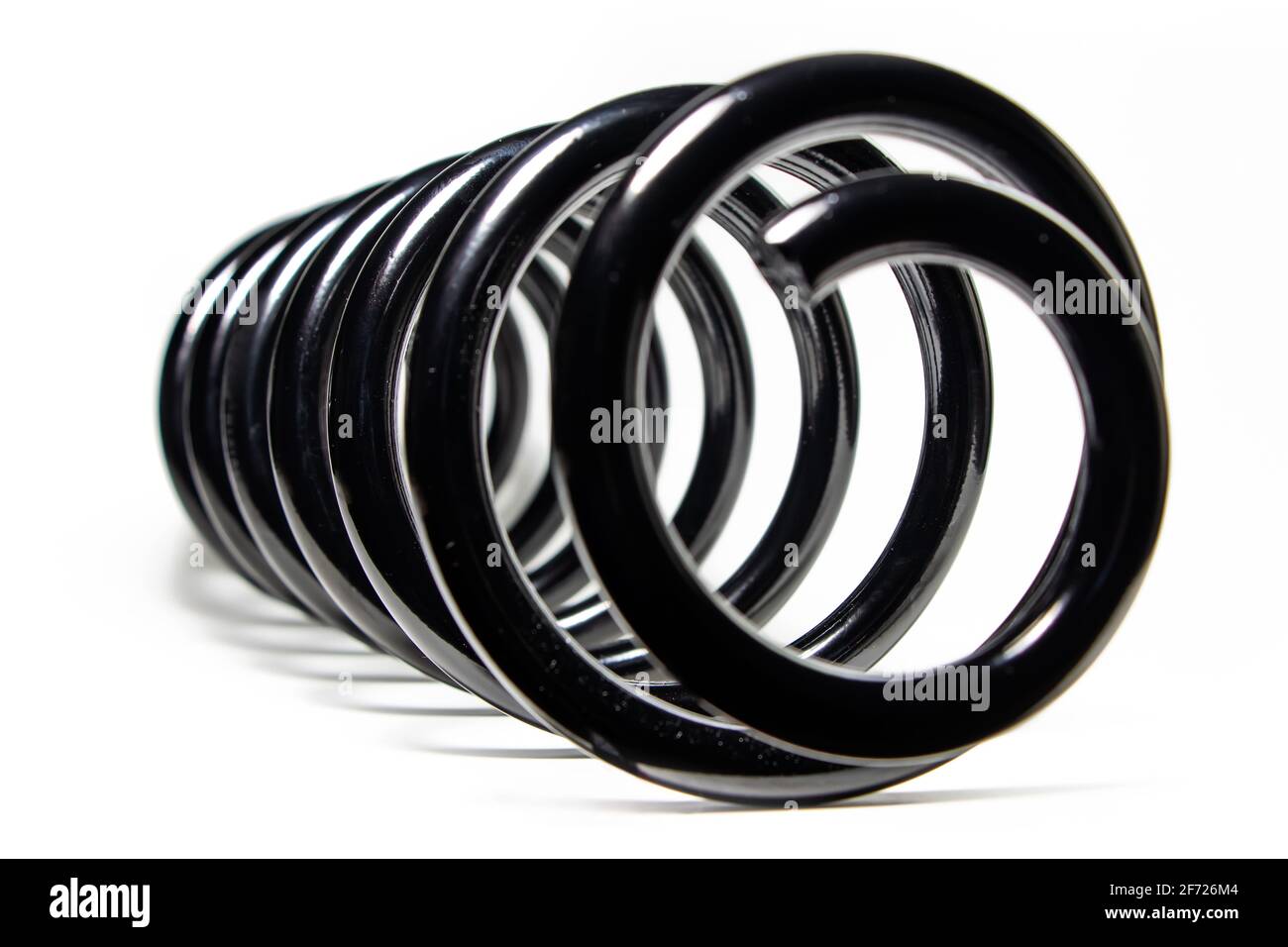 Dark metal spring isolated on white background Stock Photo - Alamy