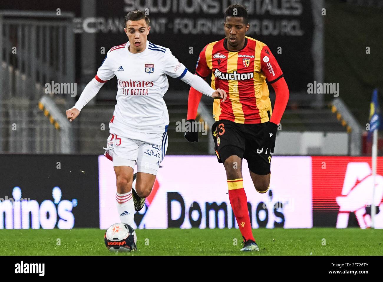 Lyon’s French midfielder Maxence Caqueret fights for the ball during ...