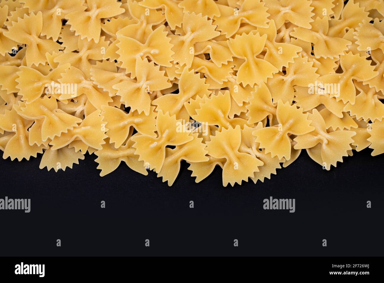 Italian raw pasta farfalle, bow tie, butterfly Stock Photo - Alamy