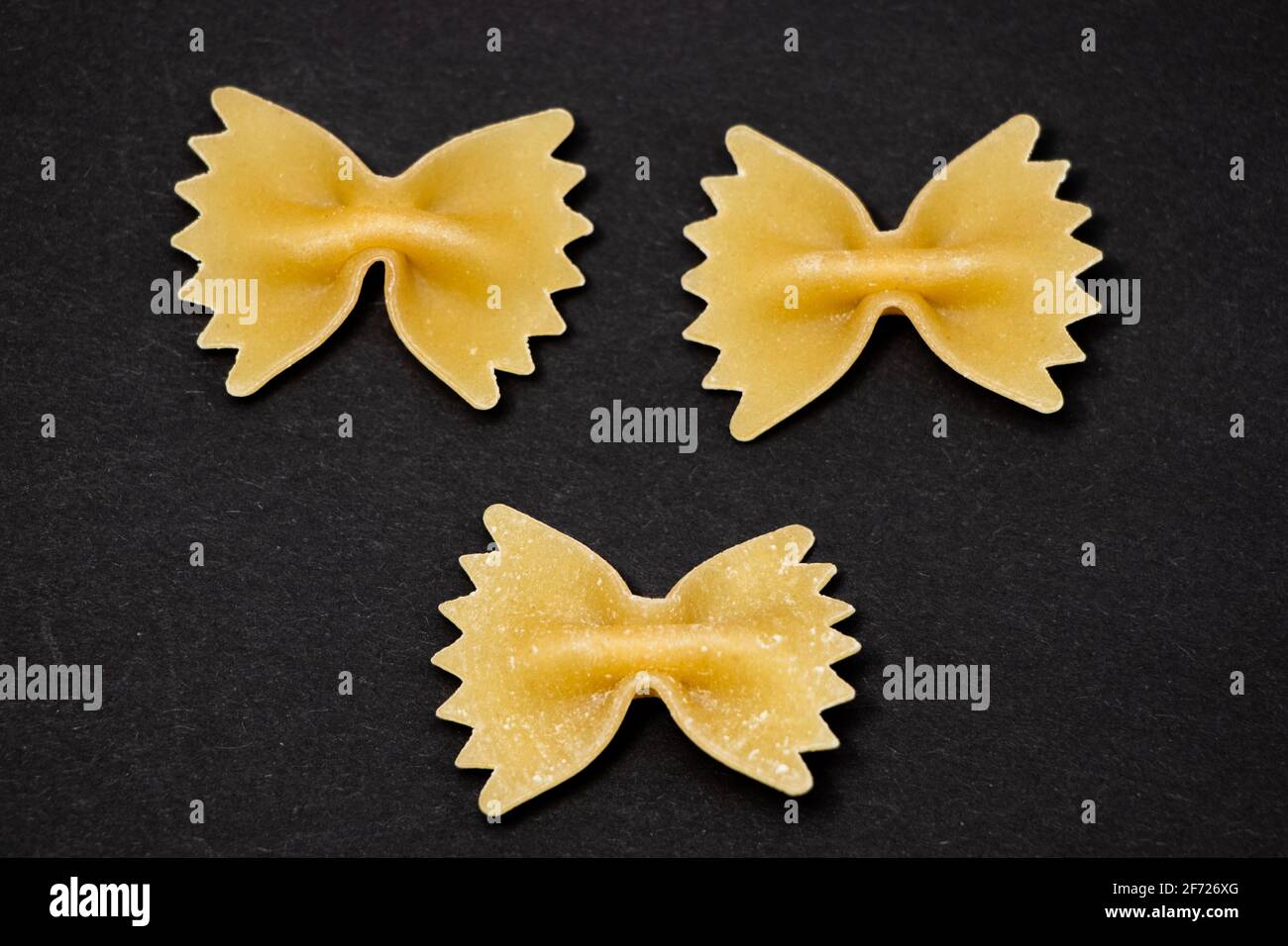 Italian raw pasta farfalle, bow tie, butterfly Stock Photo - Alamy