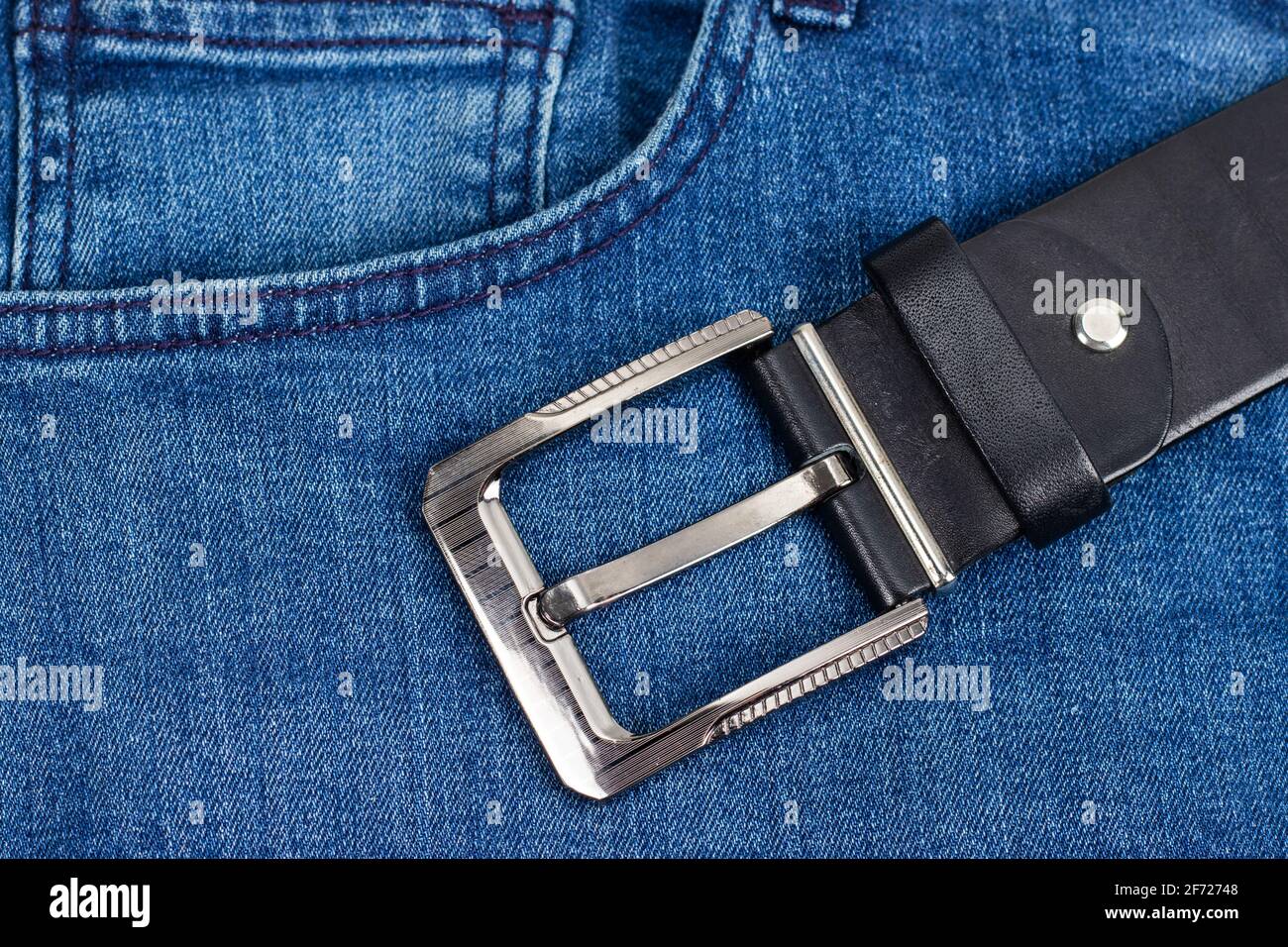 Belt and jeans closeup. Leather belt close-up. Belt and blue jeans ...