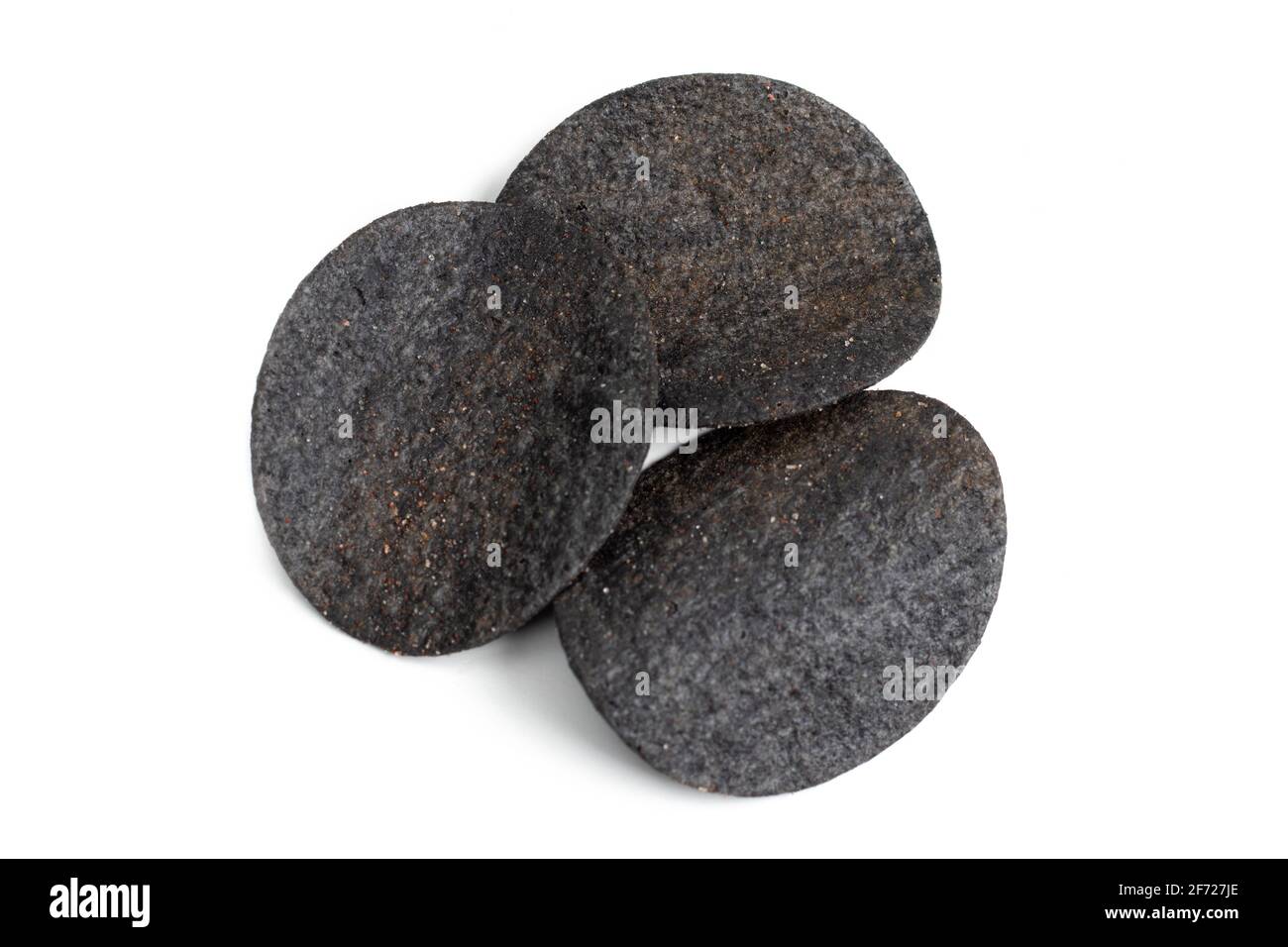 Chips black. Chips with added charcoal and peppers. White background ...