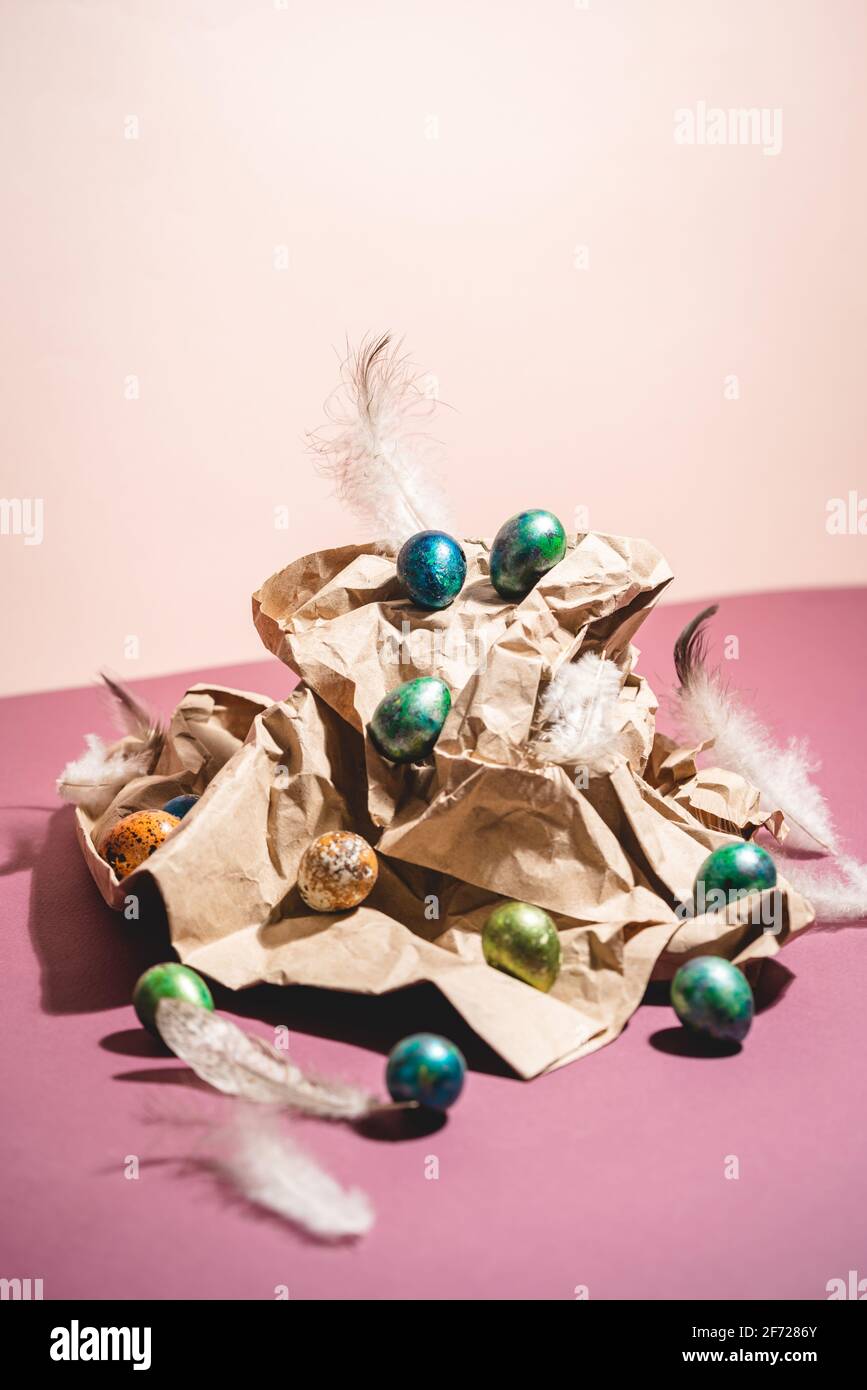 Colorful eggs in cardboard on pastel pink background. modern concept of ...