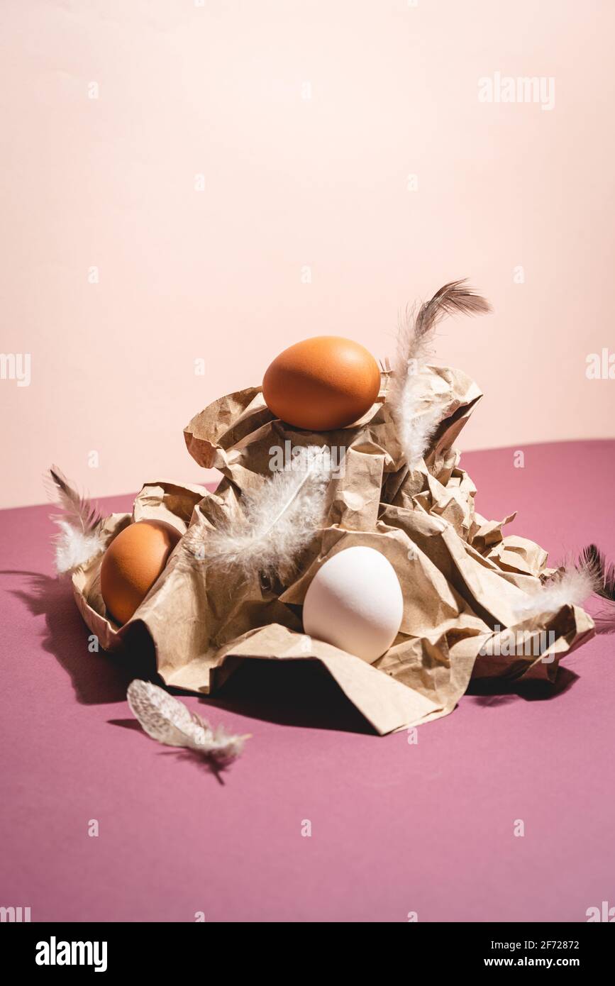 Brown eggs in cardboard on pastel pink background. modern concept of ...