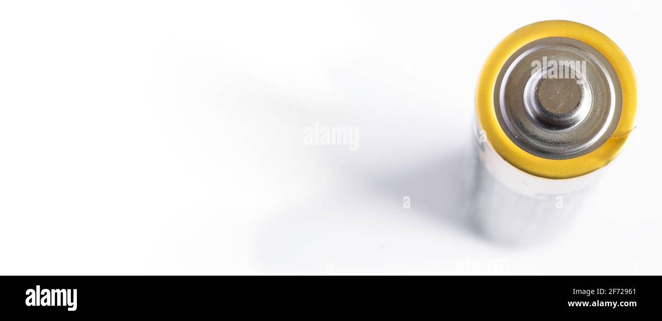 Close-up of an upright penlight battery on white with shadow, focus on ...