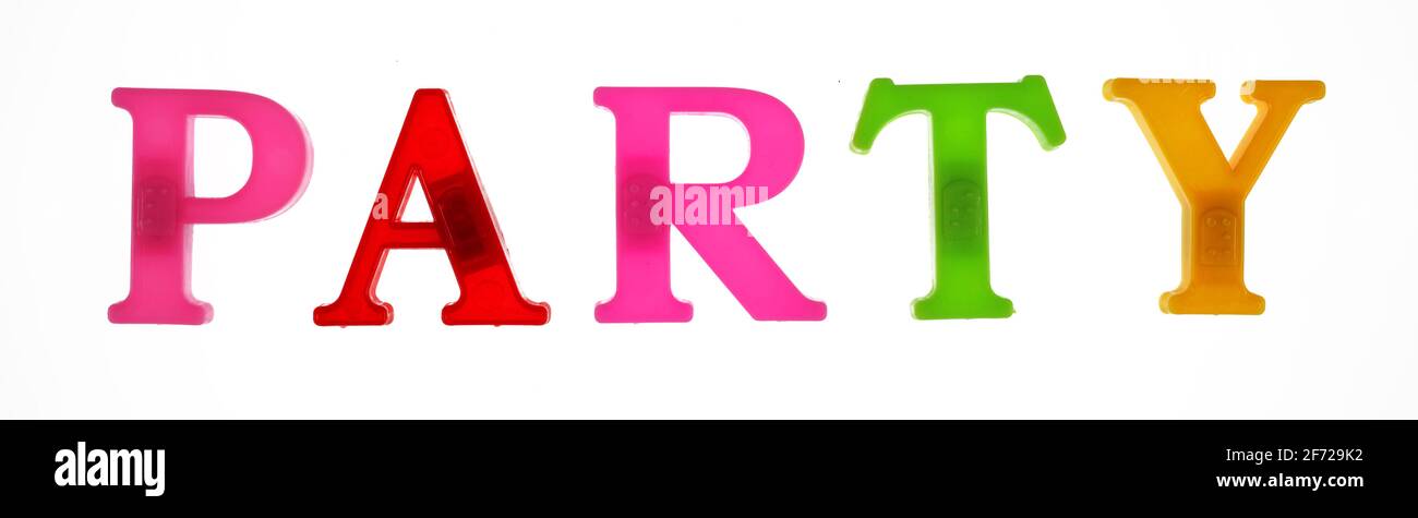 Party word lined with plastic multicolored letters on white background ...