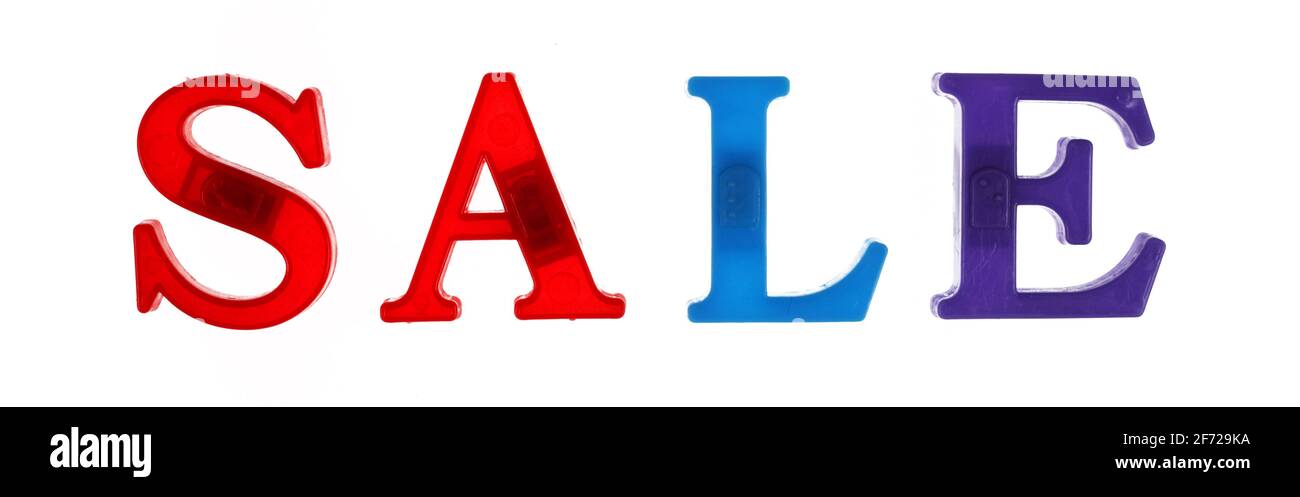 Sale word lined with plastic multicolored letters on white background ...