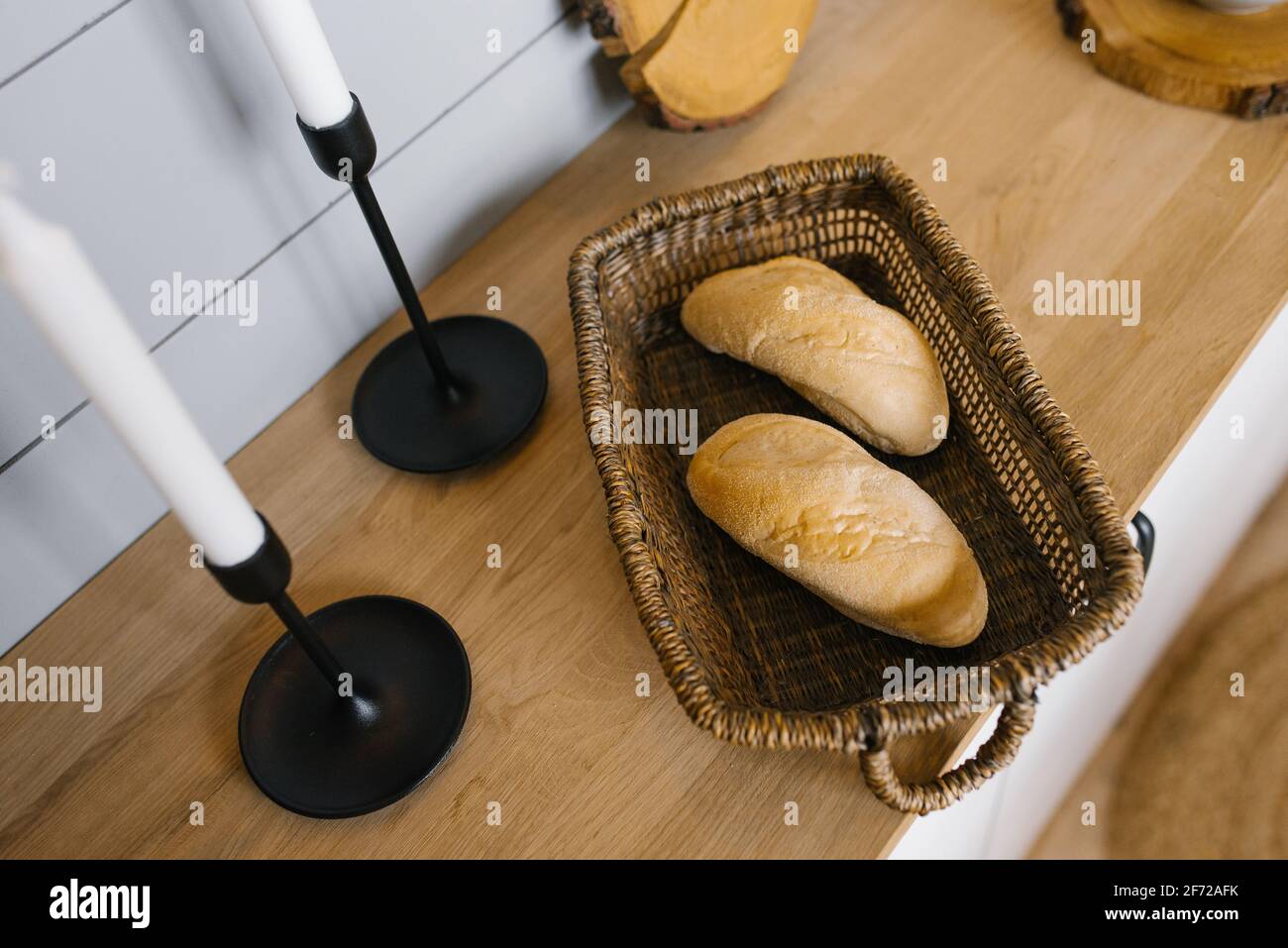 Two French bread rolls in a wicker basket on the Scandinavian-style ...