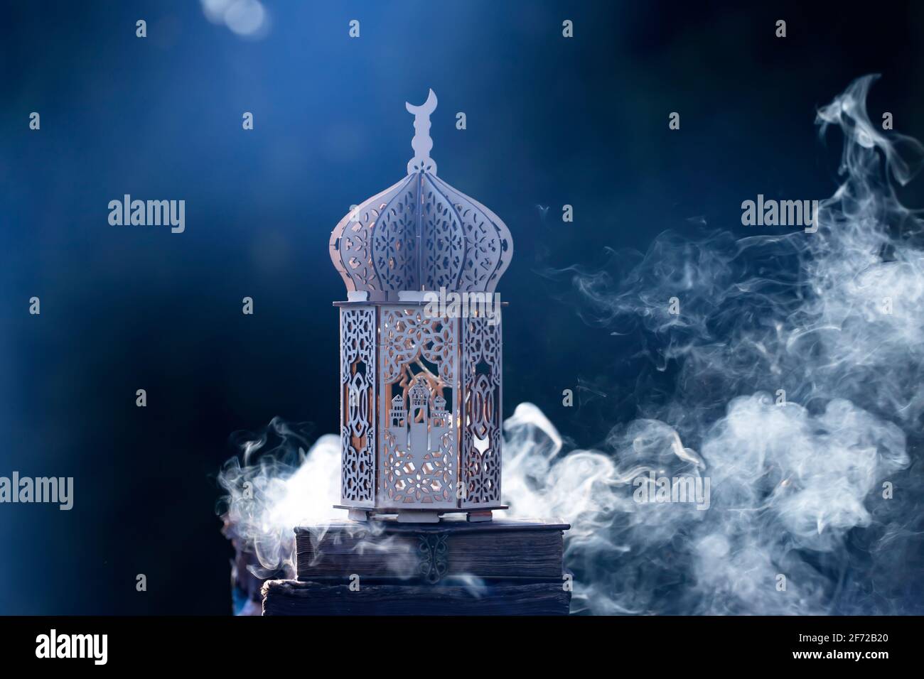 Ornamental Arabic lantern with with Holy Quran. Festive greeting card ...