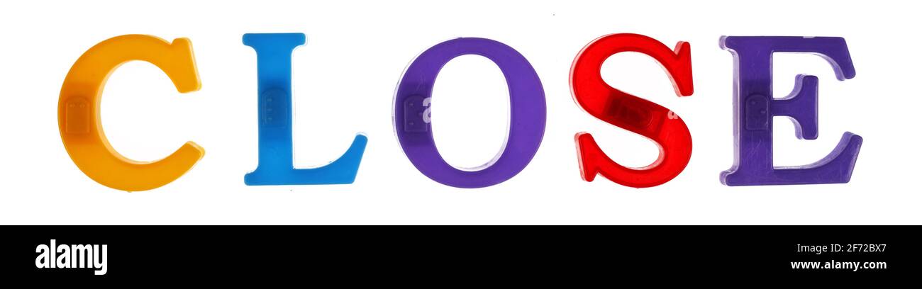 Close word lined with plastic multicolored letters on white background ...