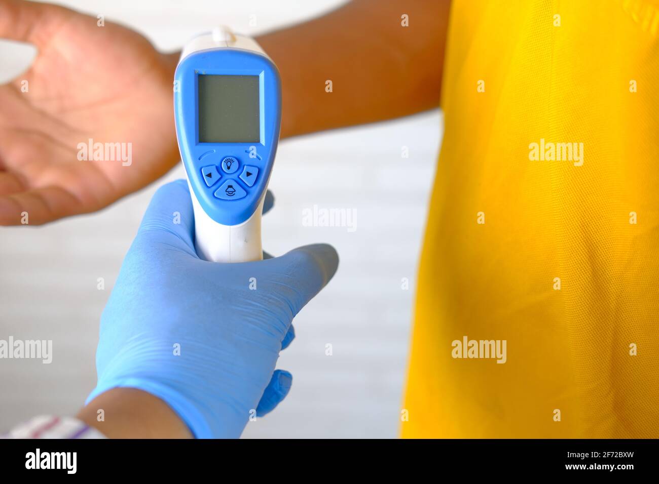 Hand holding infrared thermometer to measuring temperature Stock Photo ...