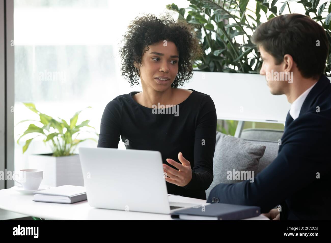 Multiethnic business partners discussing project hi-res stock ...