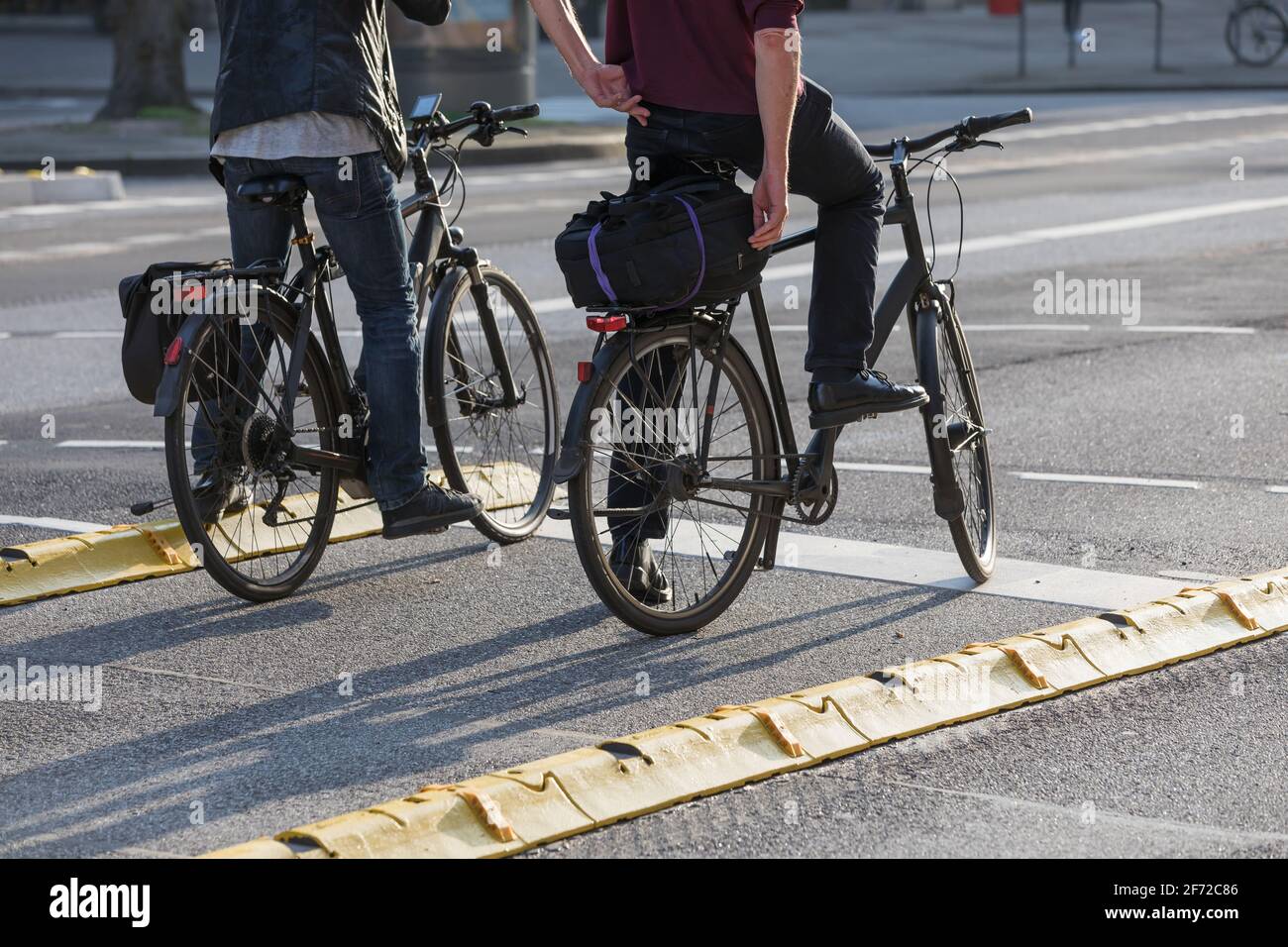 cyclists waiting on a protected bike lane Stock Photo - Alamy