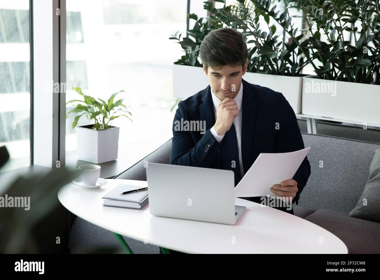 Businessman laptop computer documents hi-res stock photography and ...