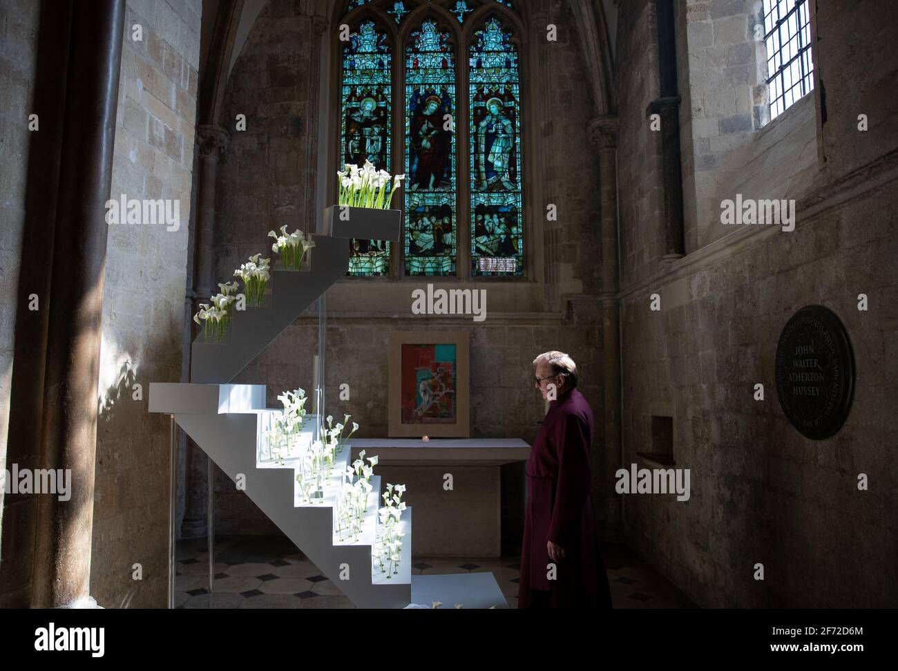 Head verger Howard Waddell looks at a floral installation made with ...