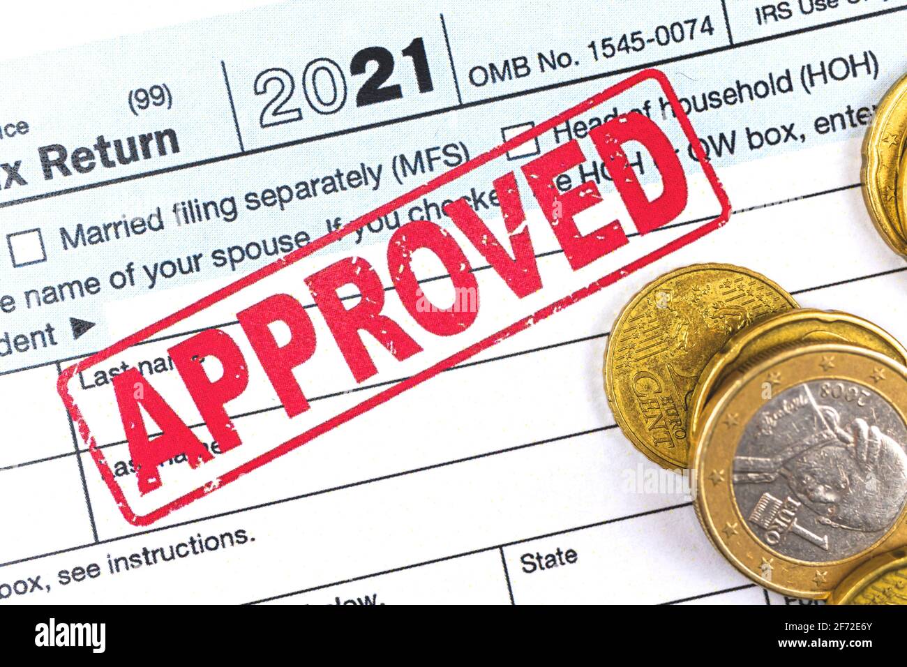 Approved stamp on tax form close up background Stock Photo - Alamy