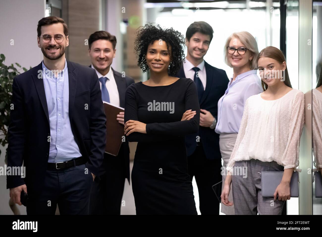 Portrait of multiracial employees pose together in office Stock Photo ...