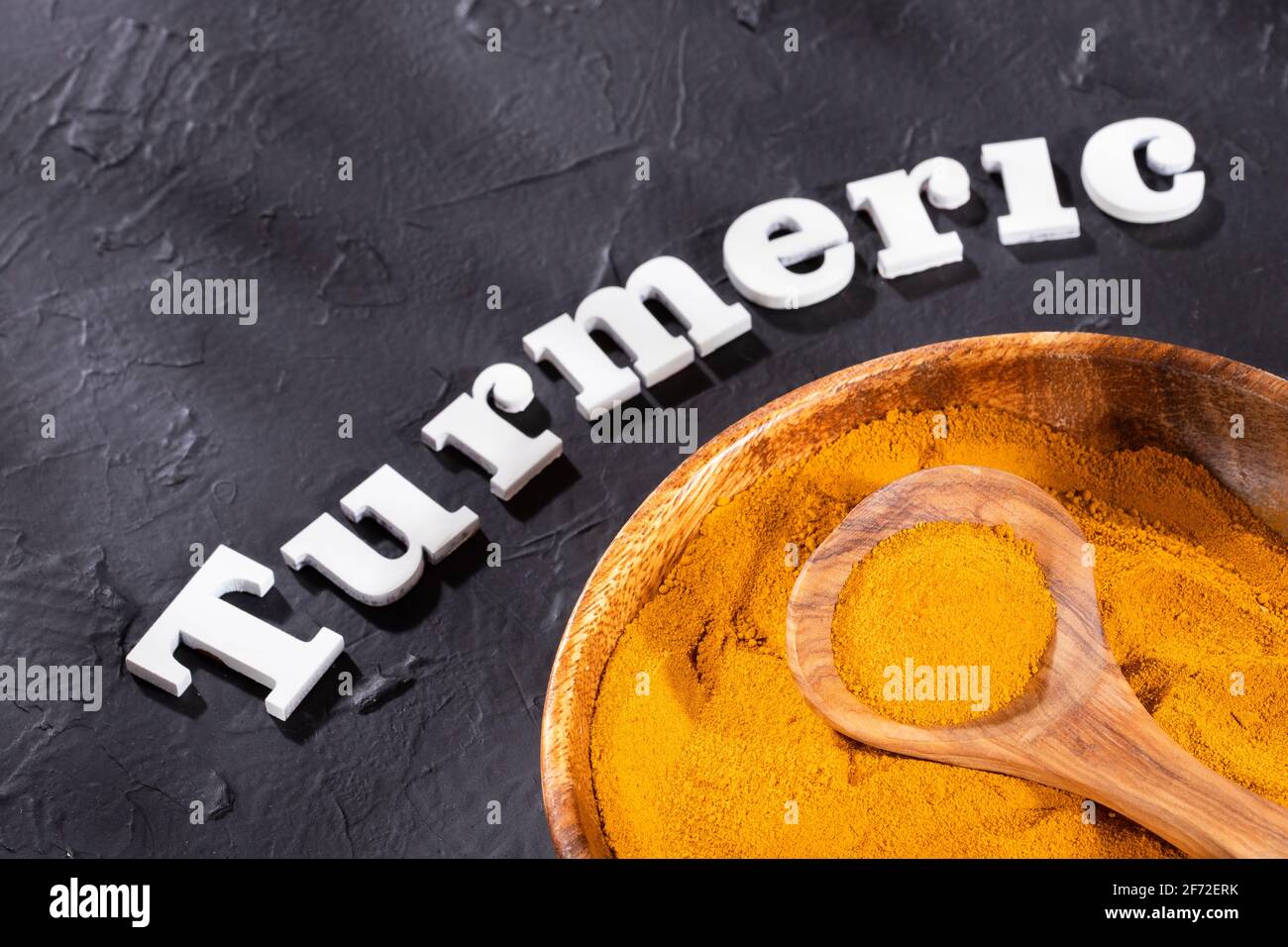 Word turmeric in wooden letters - Organic turmeric powder Stock Photo ...