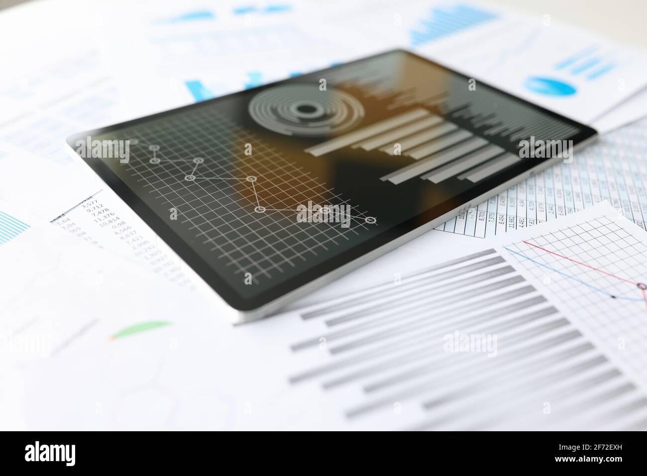 Tablet with business indicators in charts is on desktop Stock Photo - Alamy