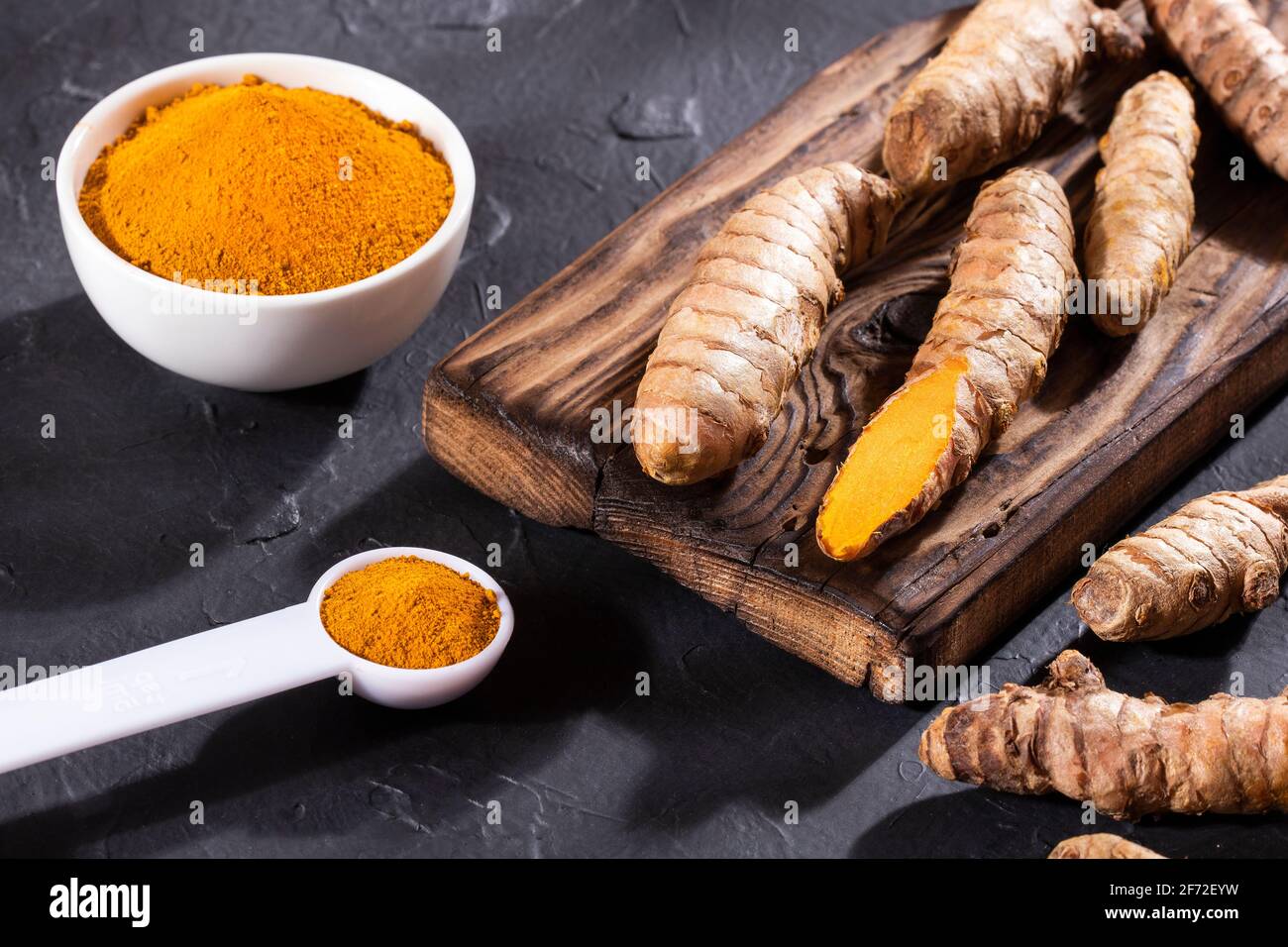 Curcuma longa - Roots and turmeric powder. Text space Stock Photo - Alamy